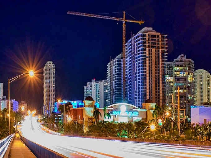 Night falls and the city lights up like a cruise ship docked on land, all sparkle and possibility.