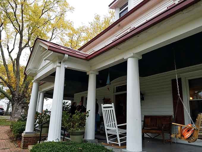 Those stately porch columns and rocking chair whisper promises of Southern hospitality at its finest.