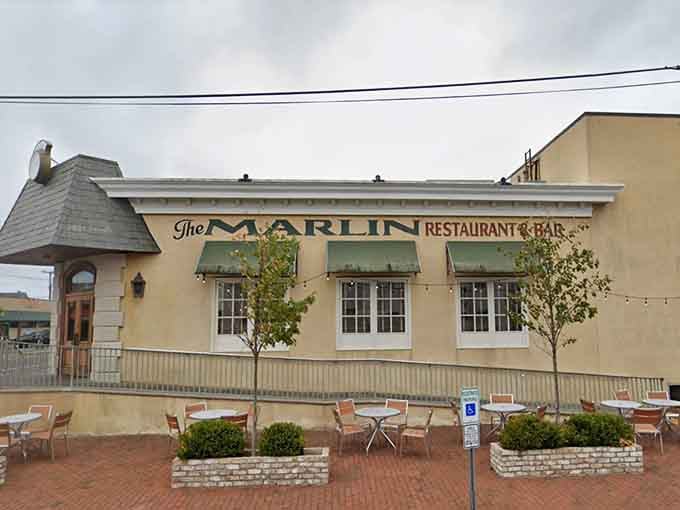 Charming outdoor seating and coastal architecture create the perfect backdrop for a leisurely seafood feast by the shore.