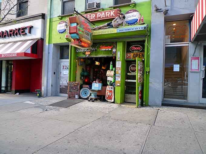 The lime green facade practically glows with personality, complete with mannequins lounging on the roof like they own the place.