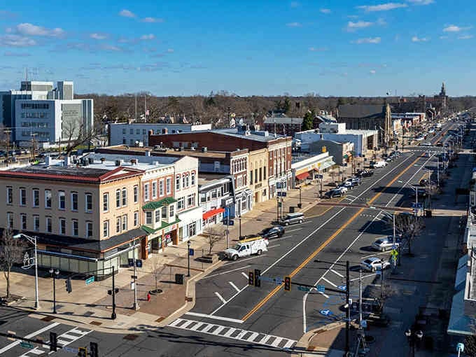 Wide streets and blue skies frame this inviting downtown where community spirit thrives in every corner shop.