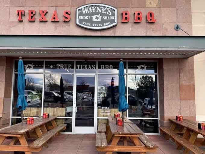 Those wooden benches flanking the entrance aren't just decoration—they're where BBQ dreams begin on sunny afternoons.