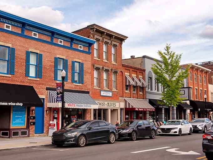 Striped awnings and brick facades create a streetscape that looks like Norman Rockwell painted it himself on a sunny afternoon.