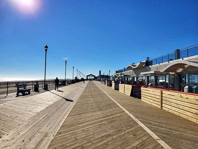 The boardwalk stretches toward forever, inviting morning joggers and sunset seekers to find their perfect ocean moment here.