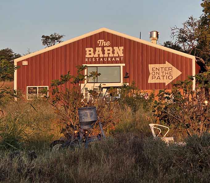 The Barn Restaurant sits pretty in golden hour light, promising meals worth the drive and memories worth keeping.