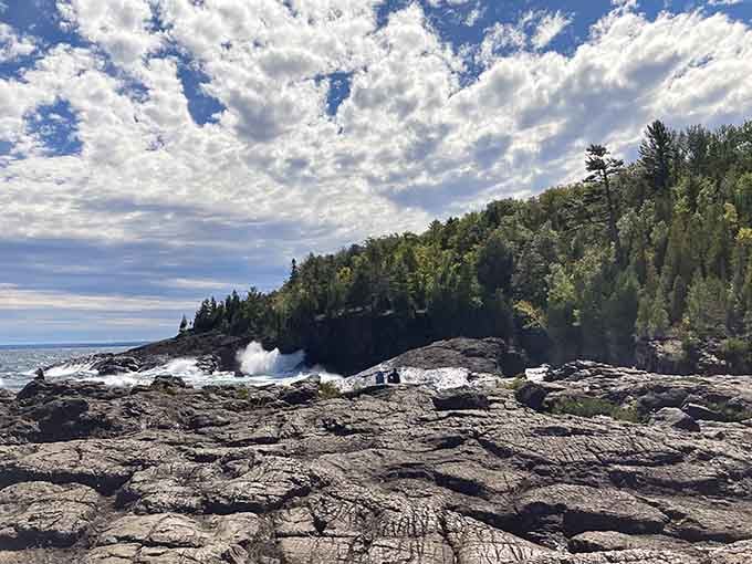 The dark basalt formations create a dramatic stage where Lake Superior performs her greatest hits daily.