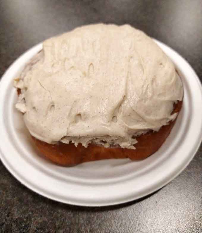 Behold the apple cinnamon bismarck, crowned with frosting so generous it could double as a winter hat.