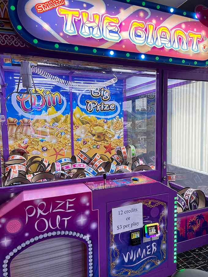 The Giant claw machine tempts you with treasures like a carnival barker who knows exactly which prize you're eyeing.