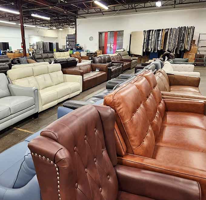 Leather sofas stretching into the distance like a furniture showroom that forgot to charge showroom prices, bless them.