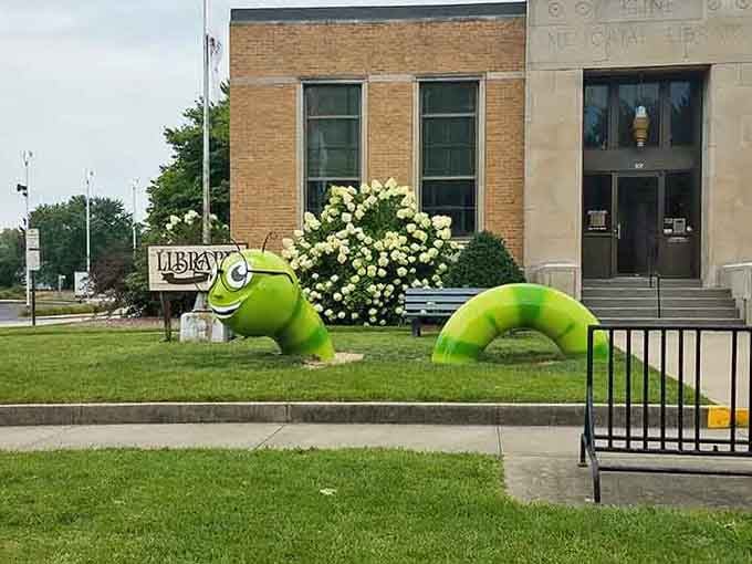 A bright green bookworm sculpture guards the library, reminding everyone that reading opens doors to giant-sized adventures.