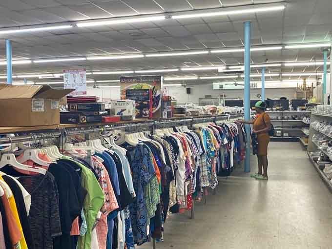 Rows of clothing stretch endlessly like a fabric rainbow where yesterday's wardrobe becomes tomorrow's perfect find.