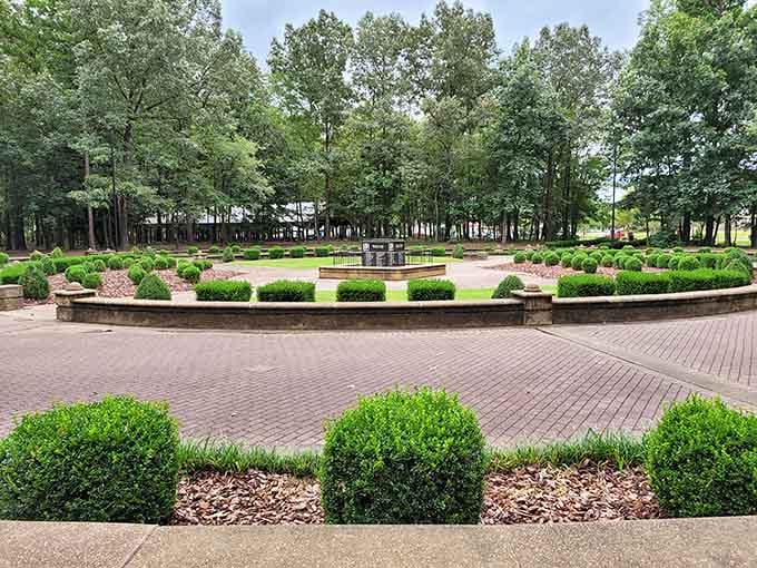 Perfectly manicured hedges and brick pathways create a garden sanctuary that would make any landscape designer weep with joy.