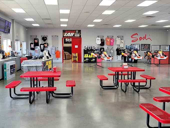 Inside, red picnic tables and racing gear create a pit stop vibe that says "serious fun happens here."