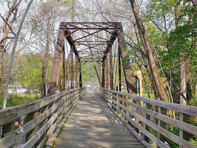 Walking across this historic metal bridge feels like stepping into a postcard your grandparents might've sent decades ago.