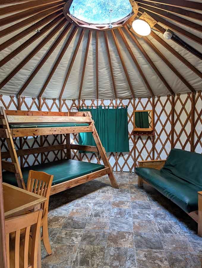 Inside a yurt, bunk beds and a futon prove that "roughing it" has gotten significantly more comfortable since your childhood camping days.