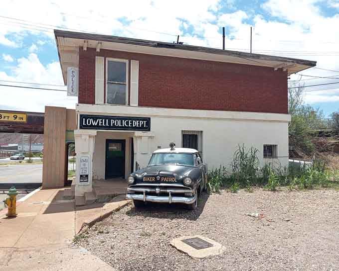 The Lowell Police Department still stands guard with its vintage cruiser, protecting a town frozen in chrome and memories.