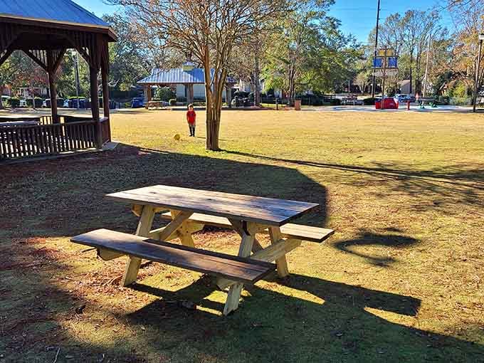 Classic picnic tables under mature shade trees prove that simple pleasures never go out of style.
