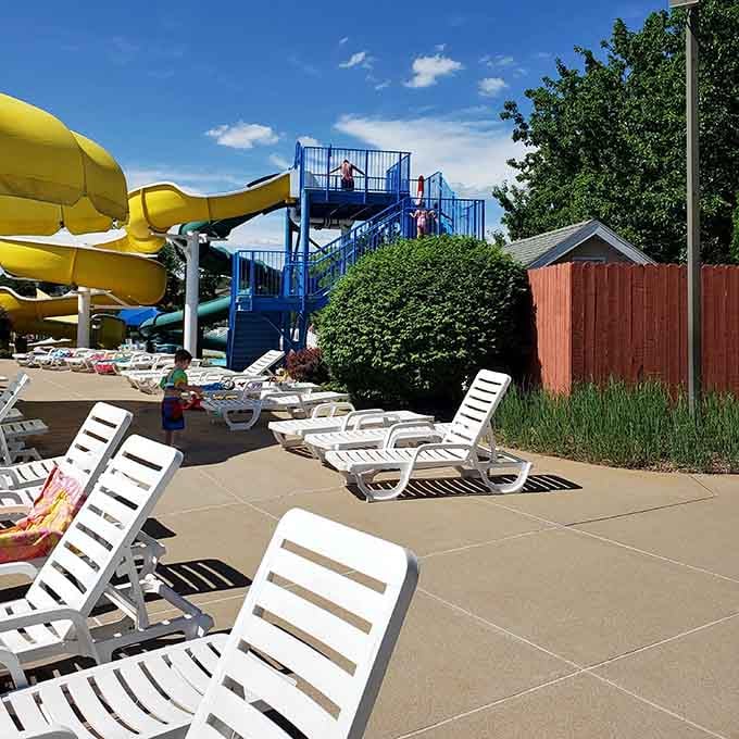White lounge chairs lined up like soldiers ready for duty, the perfect command center for supervising summer chaos.