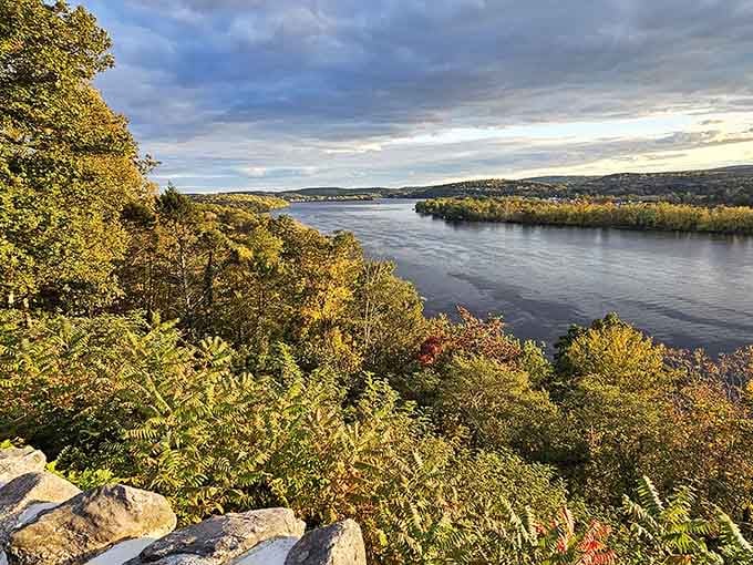 The Connecticut River stretches below like a painter's masterpiece, proving the best views require a castle-sized commitment.