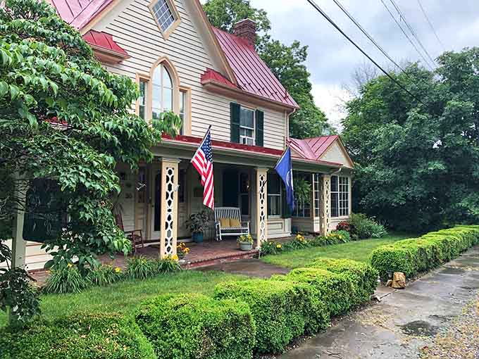 The Hummingbird Inn sits pretty with its red roof and front porch, inviting you to slow down already.