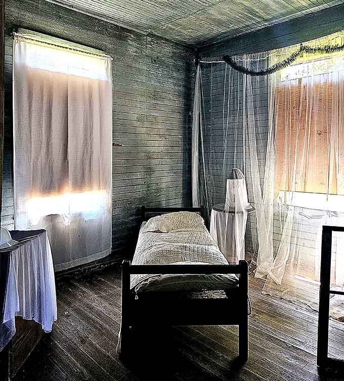 Simple iron bed frames and gauzy curtains recreate the modest living quarters of textile workers from decades past.