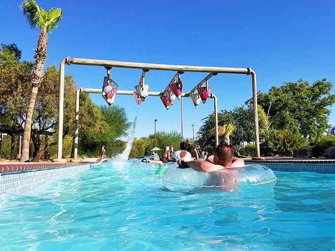 Floating down the lazy river with flags overhead, because even relaxation deserves a little patriotic flair.