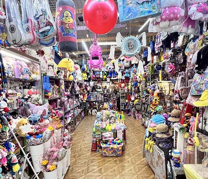 This toy aisle looks like Santa's workshop exploded in the best possible way, with treasures reaching toward the ceiling.