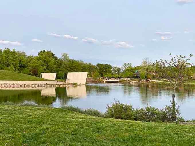 Peaceful waters reflect the sky while kids create joyful chaos just beyond the frame, perfectly balanced.