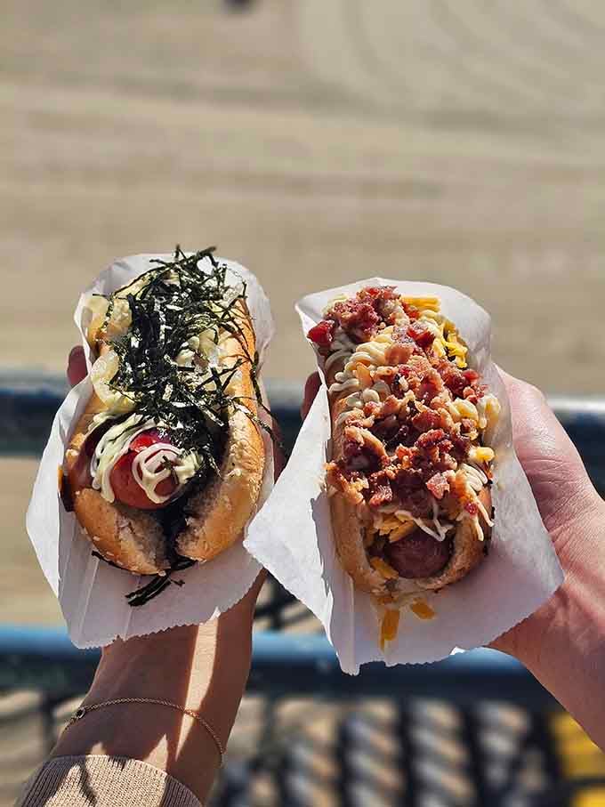 Two masterpieces in hand, ready to redefine everything you thought you knew about hot dogs.