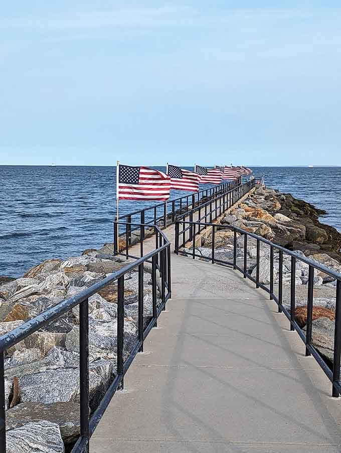 American flags wave proudly along the jetty, because patriotism and ocean views pair surprisingly well together.
