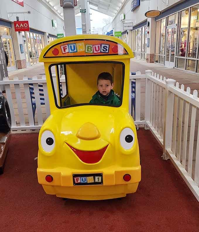 That grinning yellow bus keeps little ones entertained while parents recover from the shopping marathon they've just completed.