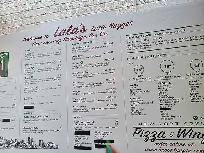 The menu board reveals Brooklyn-style pizza has found its forever home in this Christmas wonderland.