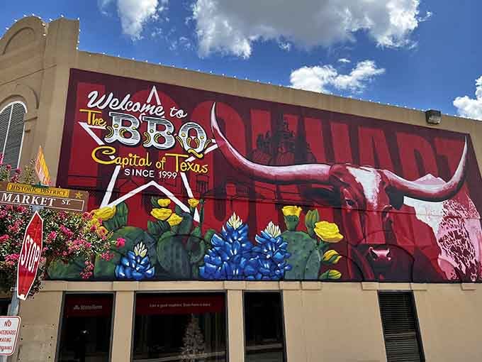 When your town mural features a longhorn this magnificent, you're not bragging, you're just stating facts about barbecue supremacy.