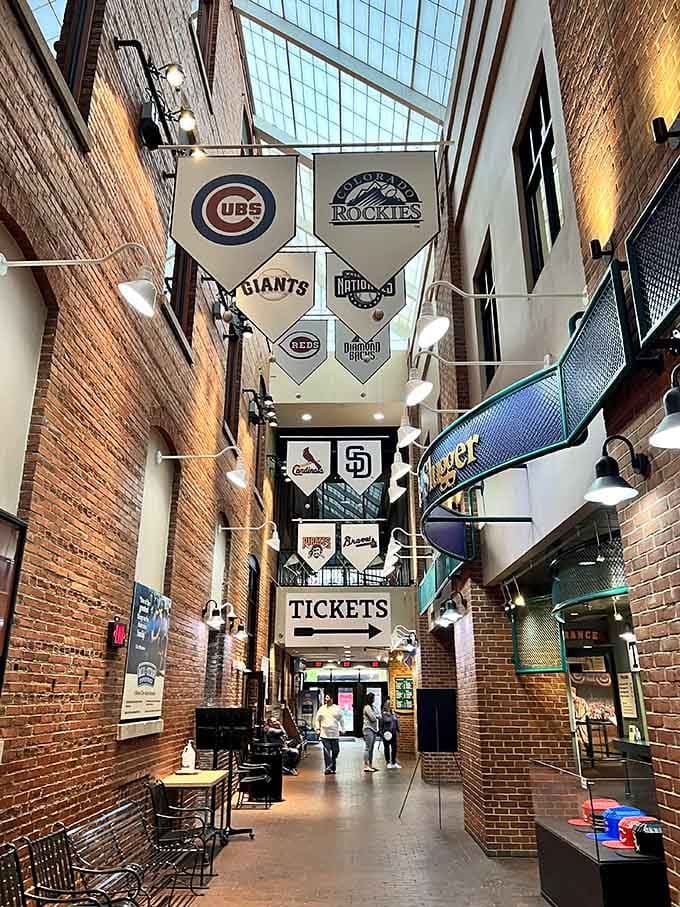 Inside, exposed brick and team banners create a cathedral-like atmosphere where baseball history hangs in the air alongside the pennants.