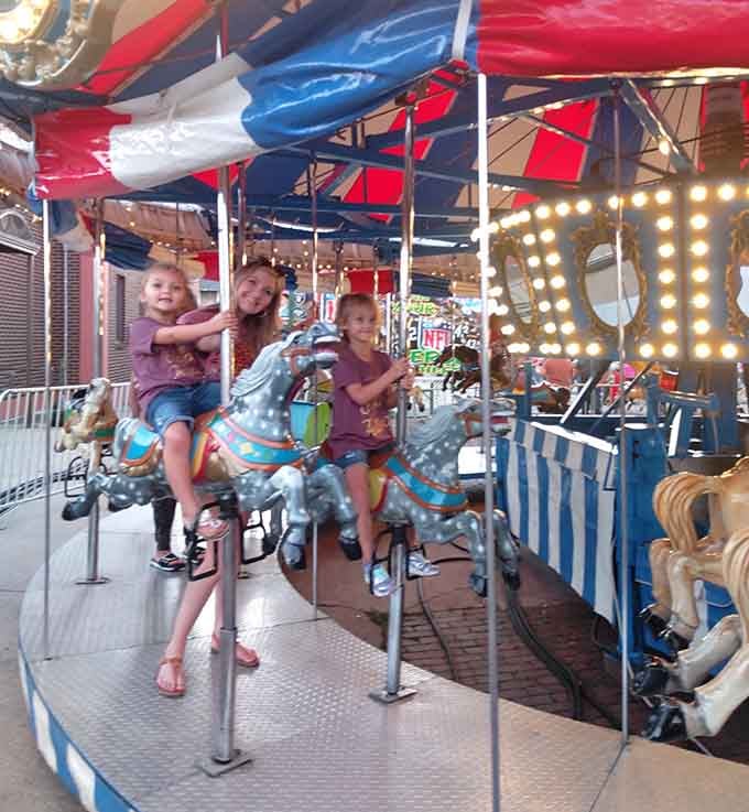 Classic carousel horses spinning under twinkling lights, because nothing says "timeless joy" quite like painted ponies and happy kids.