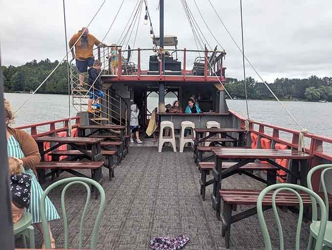 Wooden benches line the deck where families gather, proving that pirate life is surprisingly comfortable in the modern age.