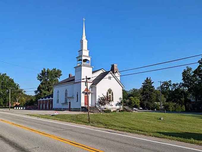 That classic white steeple reaching skyward reminds you when communities gathered every Sunday without checking their phones first.