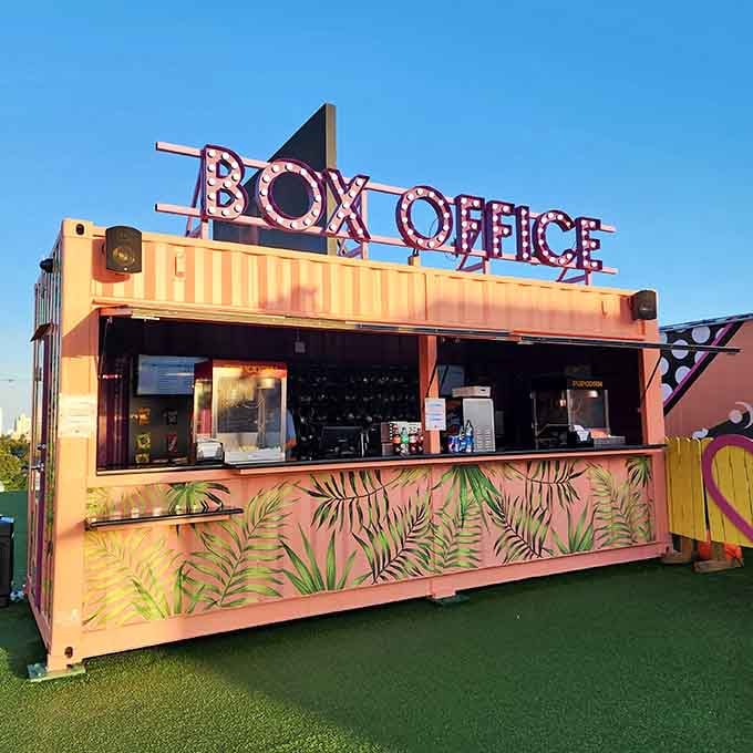 That retro box office setup looks like it time-traveled from Hollywood's golden age straight to this rooftop paradise.