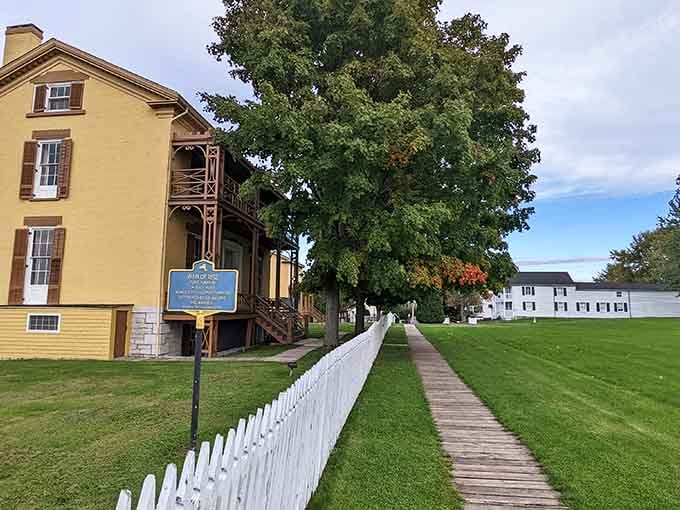 White picket fences and manicured lawns frame historic buildings where American soldiers once defended against British forces.