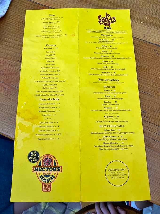 A yellow menu promising margaritas, mojitos, and enough rum cocktails to make you forget you drove here.