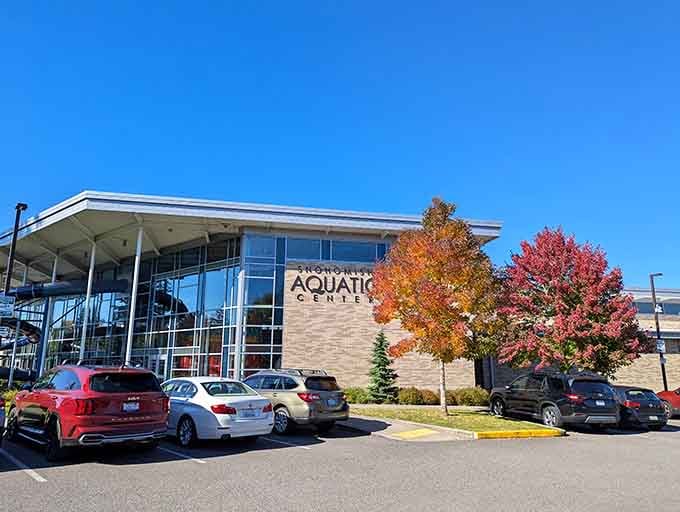 Those autumn trees flanking the Aquatic Center prove even modern facilities can coexist beautifully with natural splendor.