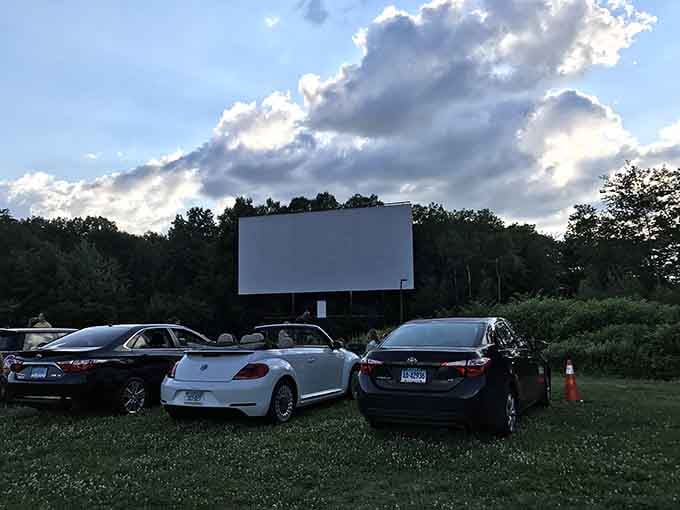As dramatic clouds stretch across the sky, cars settle in for a visit that proves some traditions refuse to fade away gracefully.