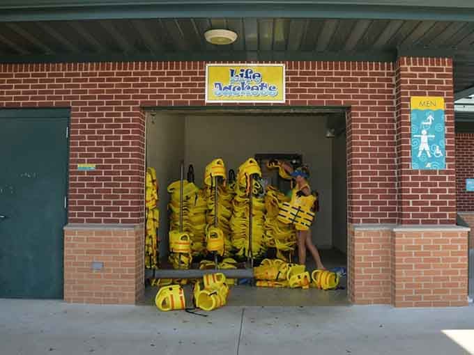 A wall of bright yellow life jackets stands ready like a cheerful army of safety soldiers.