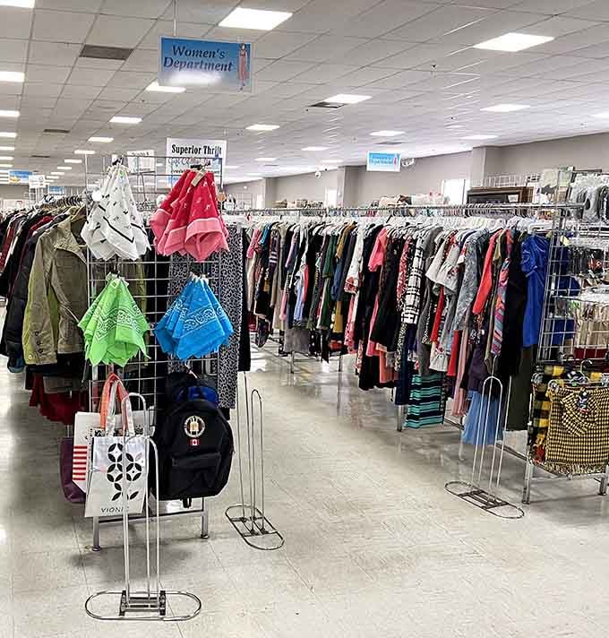 Racks stretching into the distance like a rainbow of second chances for perfectly good clothes.