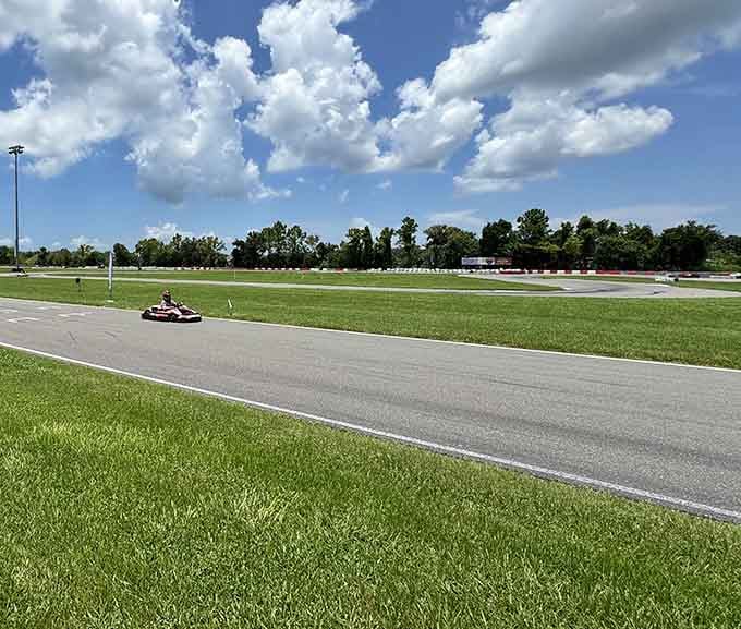 Under that perfect Florida sky, a lone kart carves through the straightaway with nothing but green grass and possibility.