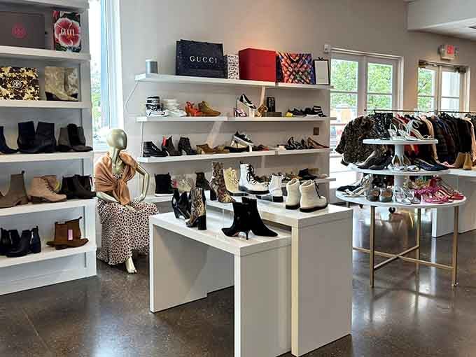 White shelving displays designer shoes like museum pieces, while Gucci boxes perch overhead reminding you this isn't your average thrift shop.