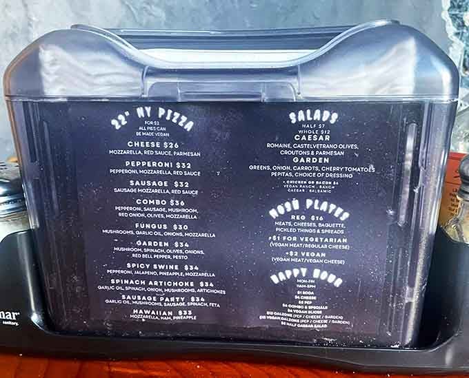 The menu board displays pizza options that prove Sasquatch has excellent taste in Italian-American cuisine.