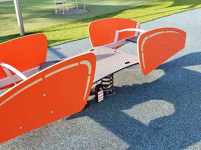 Orange seesaws on blue surfacing prove that playgrounds can be both accessible and absolutely gorgeous.
