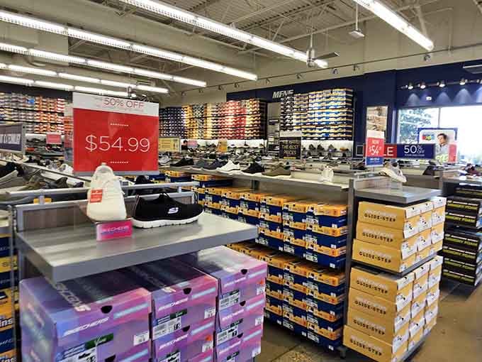 Rows of sneakers stacked like a footwear buffet, each pair whispering sweet nothings about comfort and savings.