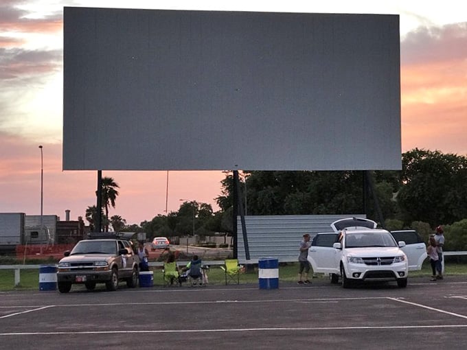 Arizona's cotton candy sunset frames the massive screen, nature's own opening act before the main feature.